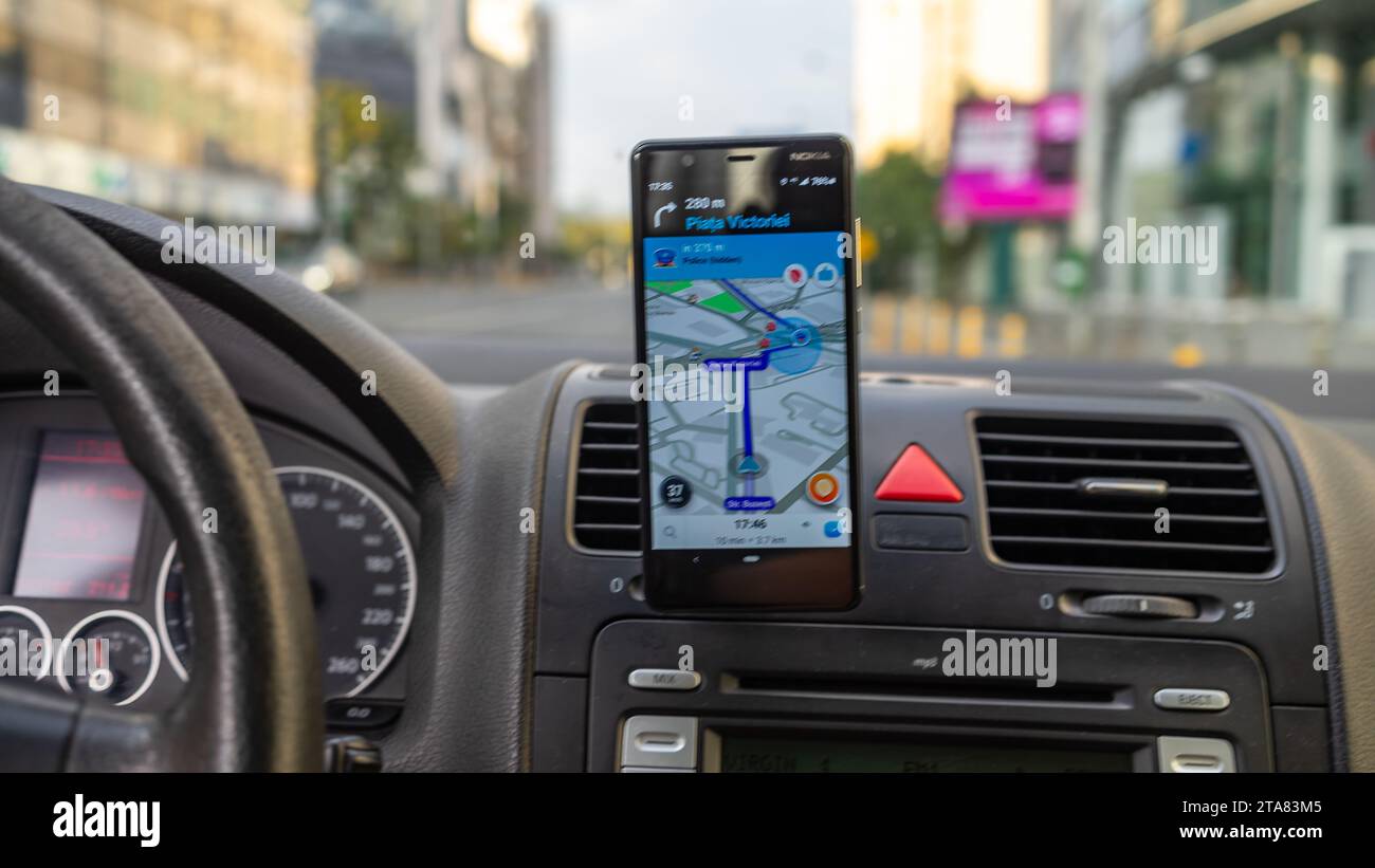Smartphone showing Waze maps to show the way thru the city. Driver ...