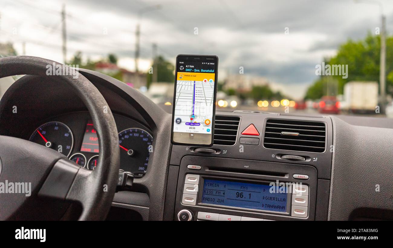 Smartphone showing Waze maps to show the way thru the city. Driver ...