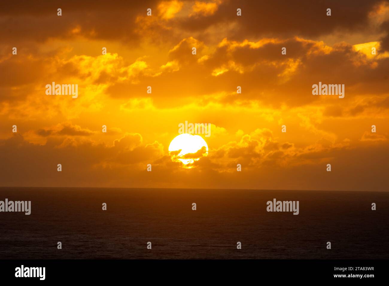 bright sunset at a beach with the very bright sun setting Stock Photo ...