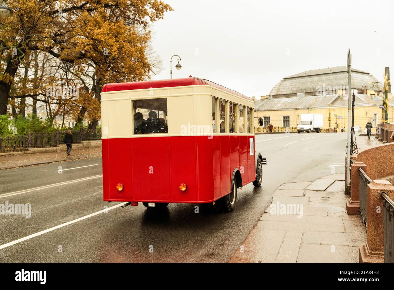 An old vintage tourist bus taking city guests on an excursion route ...