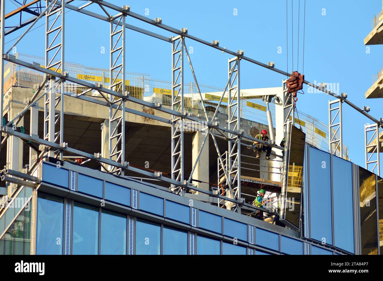 High rise building under construction. Installation of glass facade ...