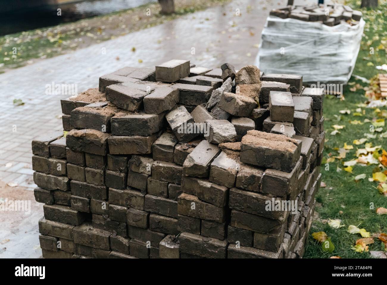 Urban Renewal: DilapA pile of worn, broken paving slabs stacked up on ...