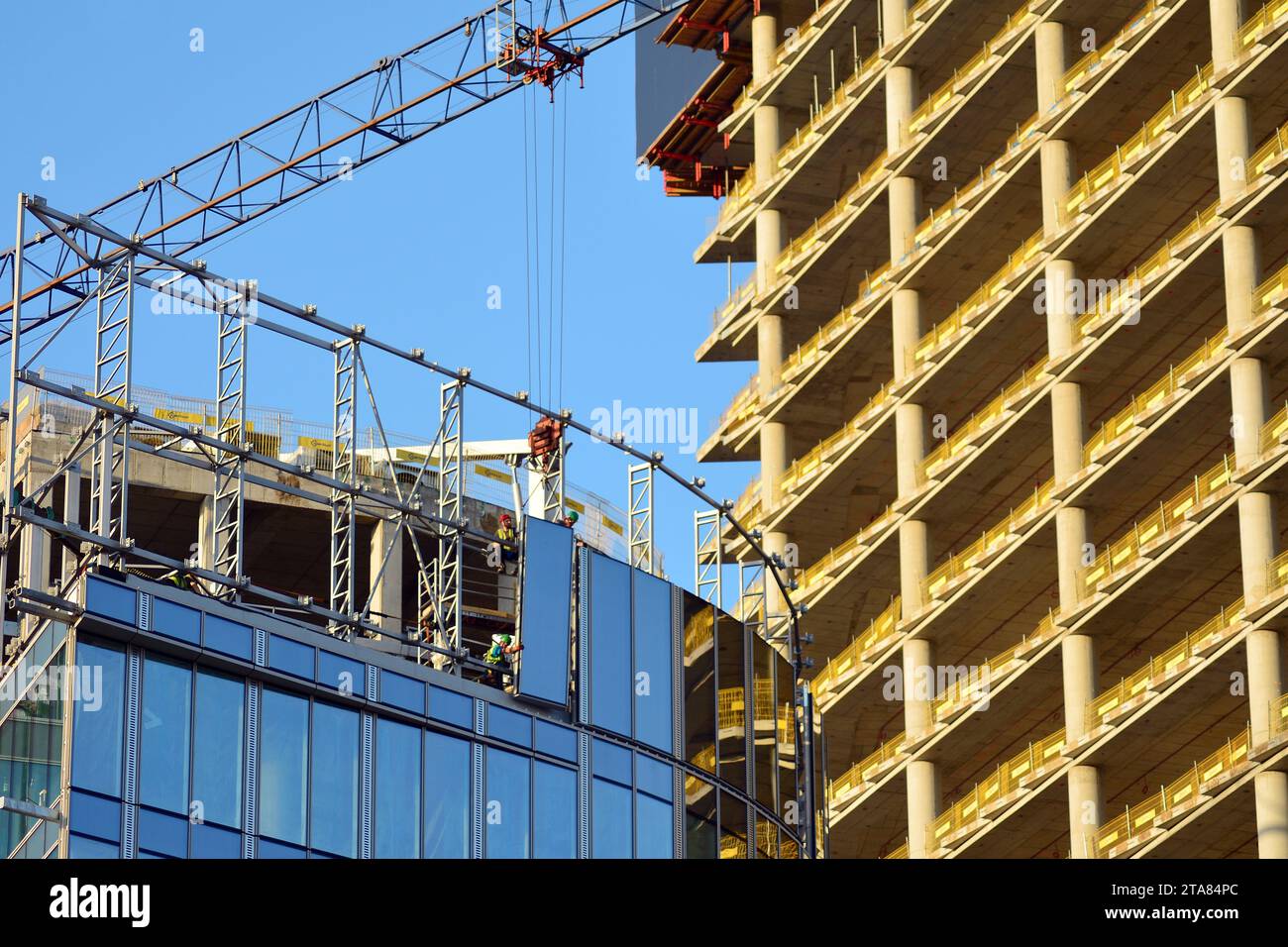 High rise building under construction. Installation of glass facade ...