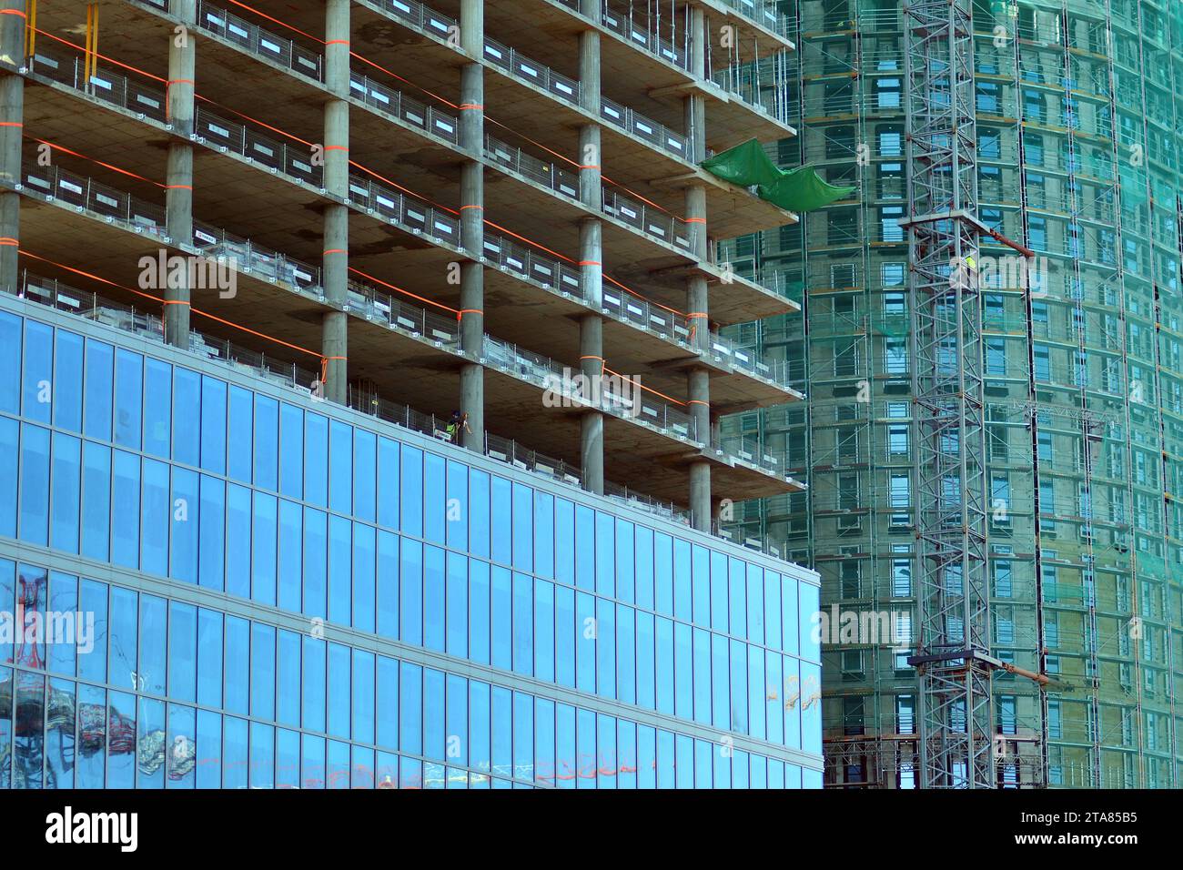 High rise building under construction. Installation of glass facade ...