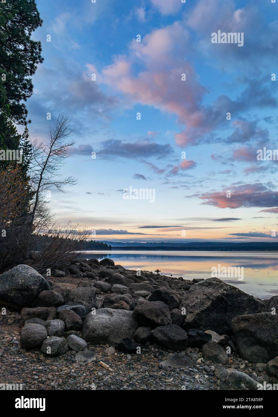 Earlyl morning sunrise light up the clouds over Peninsula Beach in ...