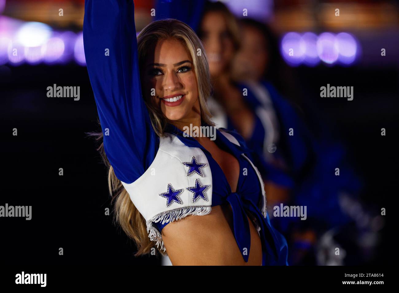 A Dallas Cowboys cheerleader performs during a regular season game ...