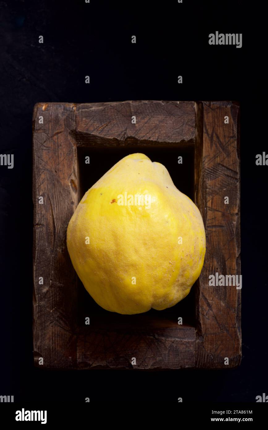 Close up of a fruit quince inside a wood box Stock Photo - Alamy