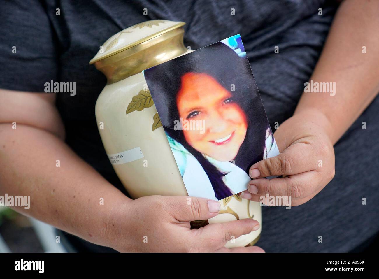 FILE- Kelly Titchenell sits on her porch in Mather, Pa., holding a ...