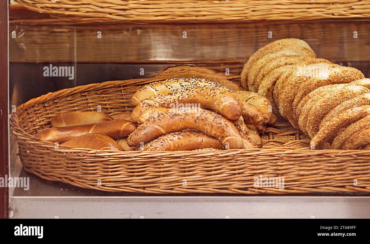 Baked rolls pile in rattan basket inside bakery interior Stock Photo ...