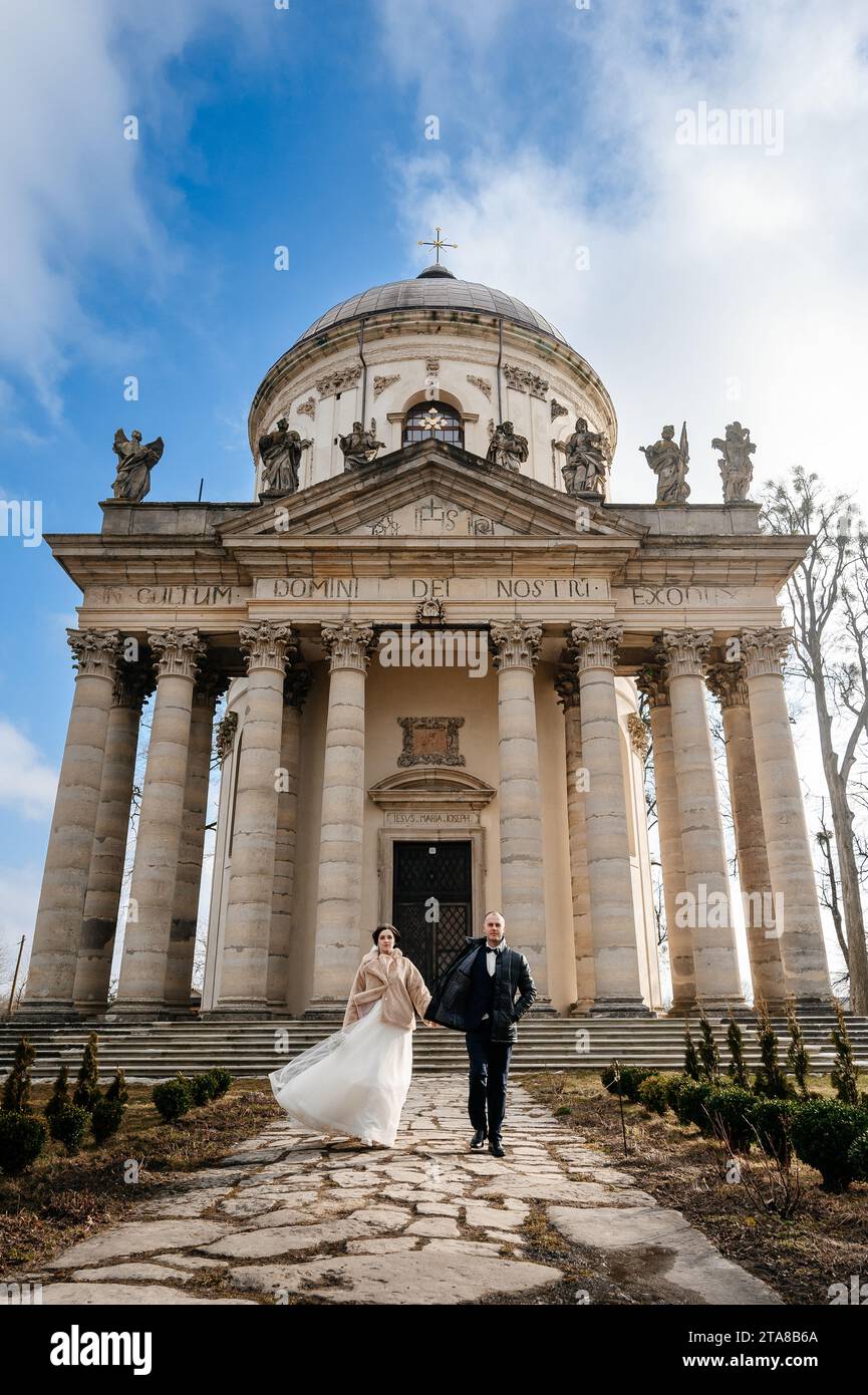 Lviv, Ukraine March 4, 2023: The bride and groom near the chapel of ...
