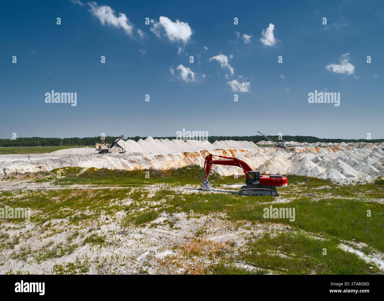 Caterpillar Shovel mining excavator near piles line in chalkquarry ...