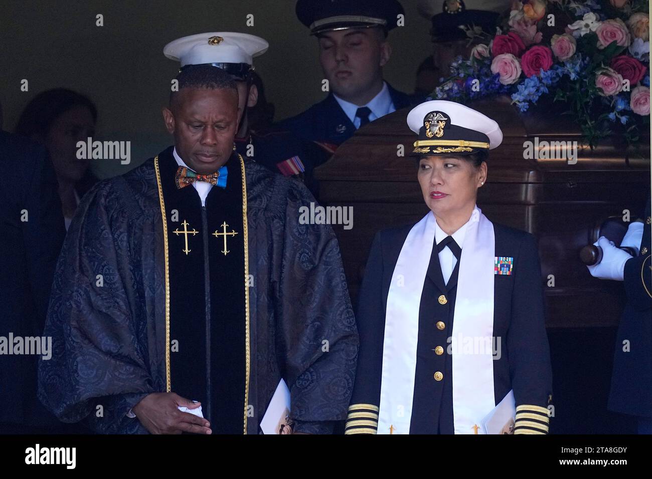Pastor Tony Lowden and Navy Chaplain Judy Malana lead the casket from ...