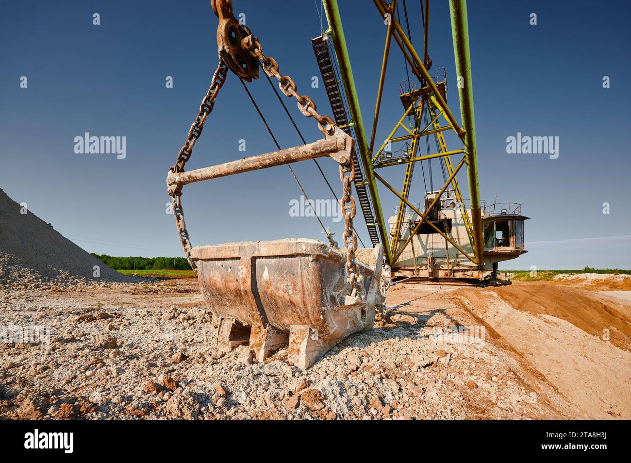 Bucket of old walking excavator digging calx in quarry Stock Photo - Alamy