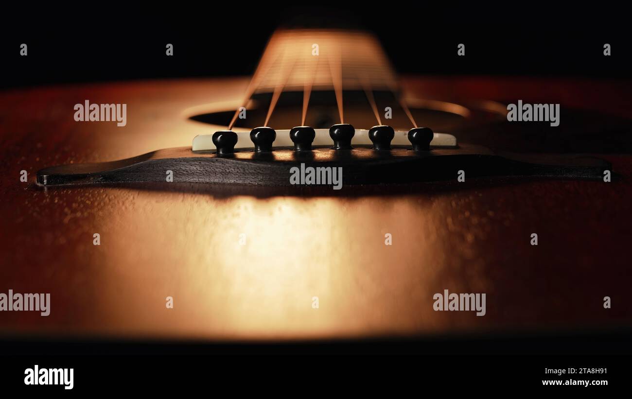 Macro of strings on redwood acoustic guitar fretboard. Classical music ...