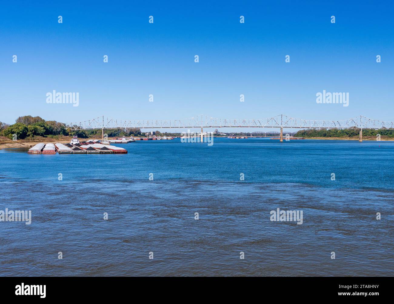 Barges wait at the confluence of the blue Ohio river and brown ...