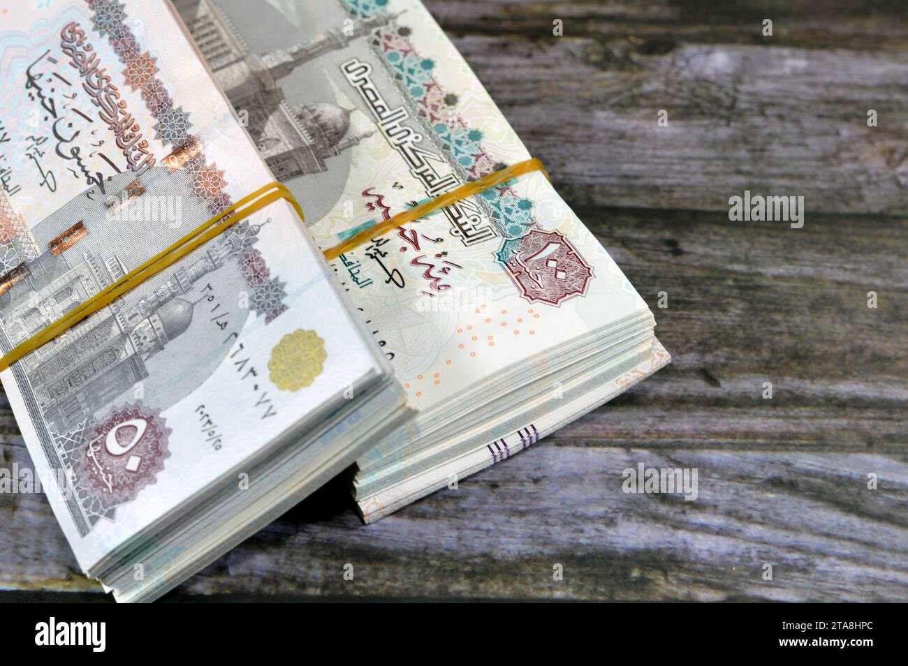 Stacks of Egypt money banknote bills of 200 EGP LE, 100 and 50 EGP LE ...