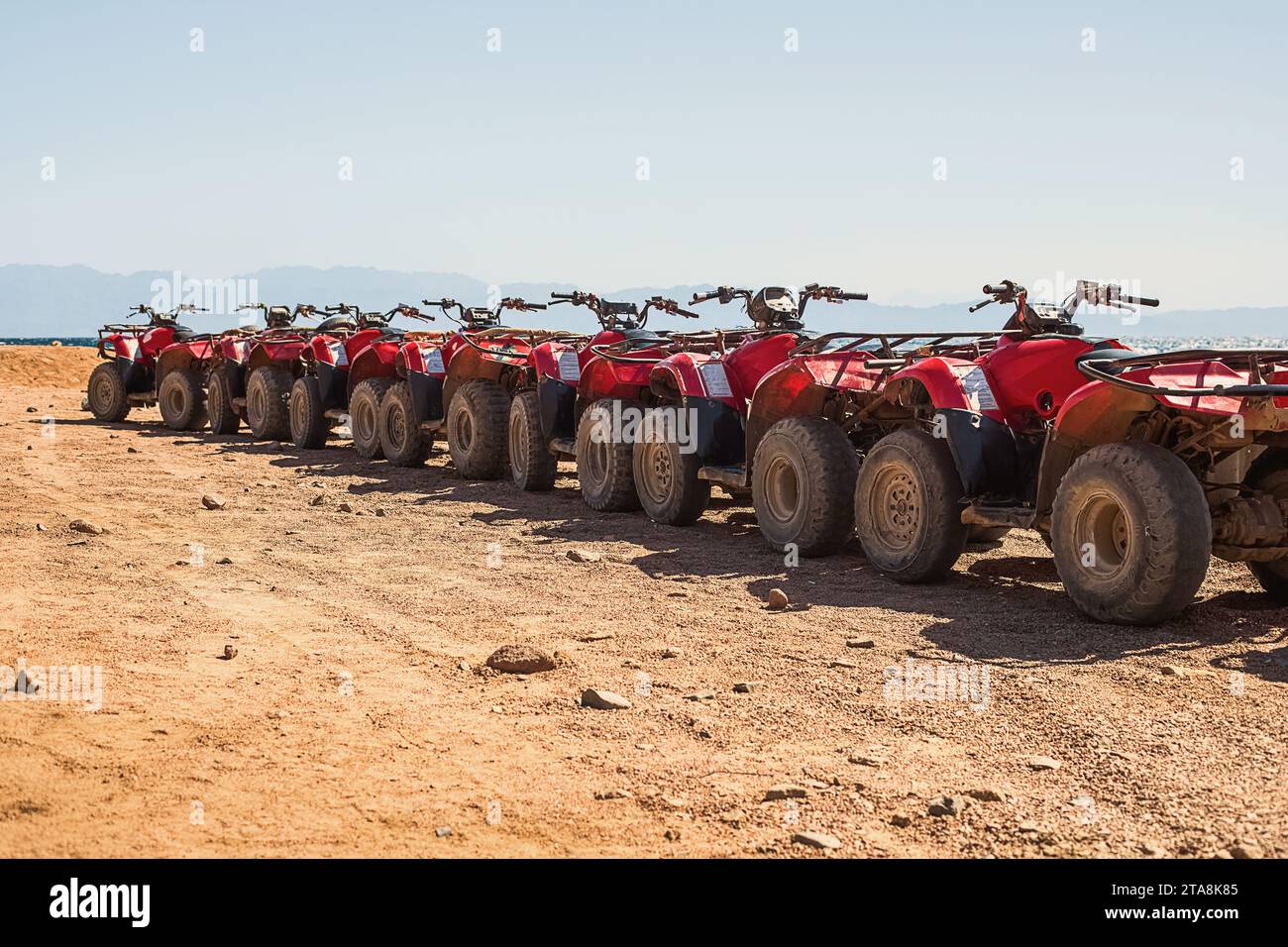Red quads stand in a row on the shore of the Red Sea. Dahab, Egypt ...