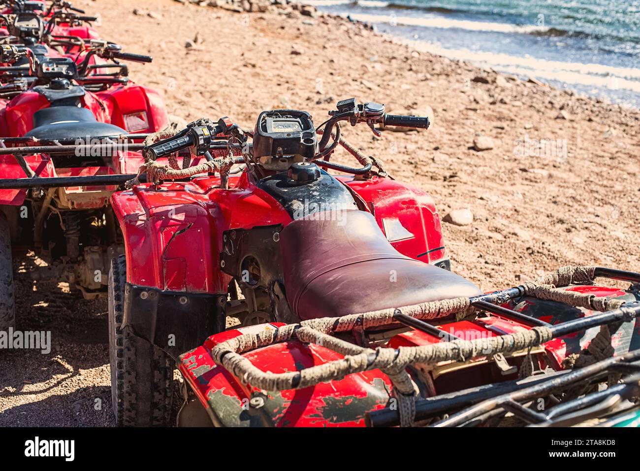 Red quads stand in a row on the shore of the Red Sea. Dahab, Egypt ...
