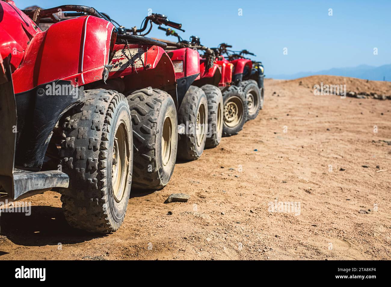 Red quads stand in a row on the shore of the Red Sea. Dahab, Egypt ...
