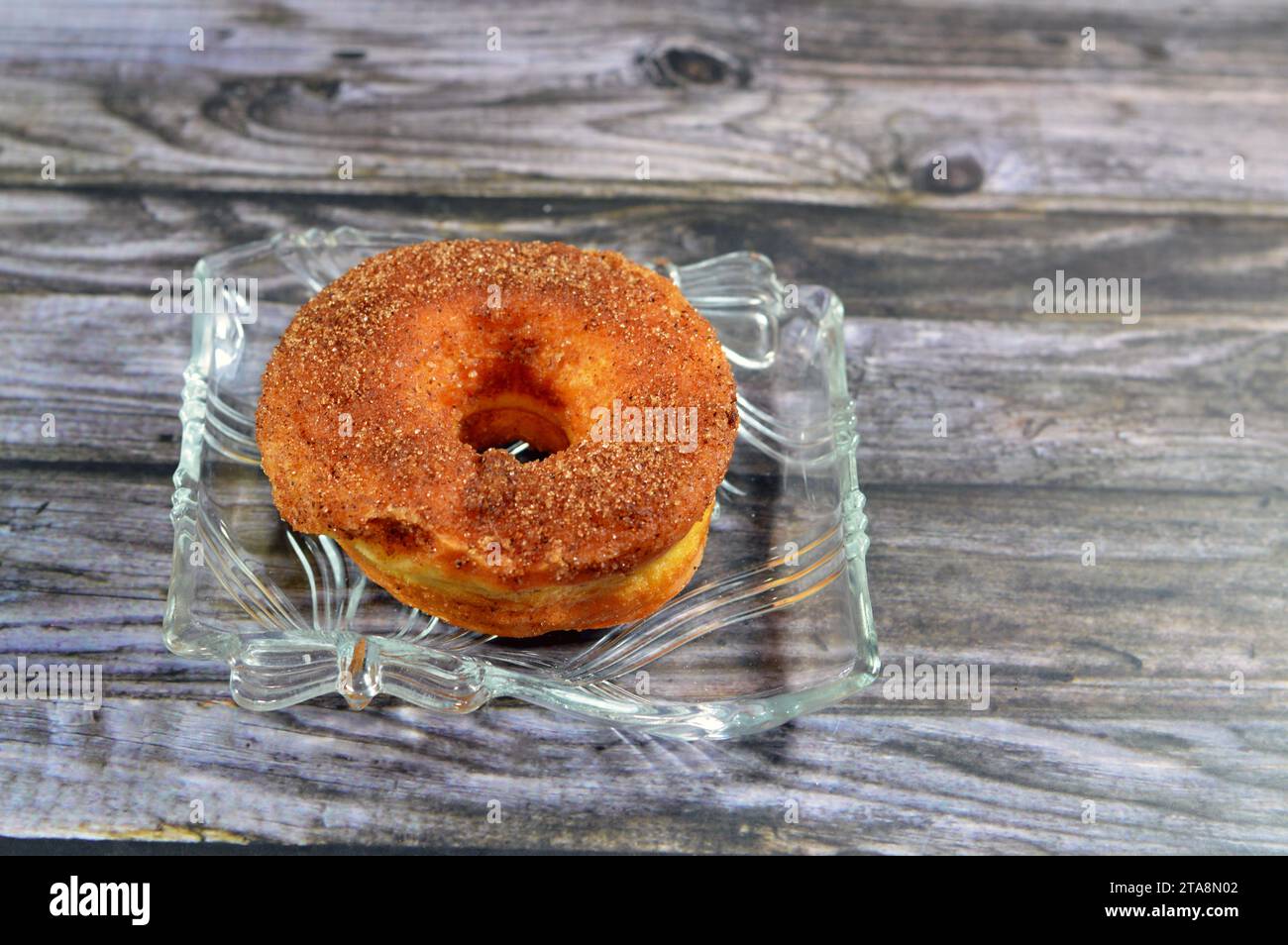 Cinnamon flavored fried sweet sugary donut, a doughnut or donut, a type ...