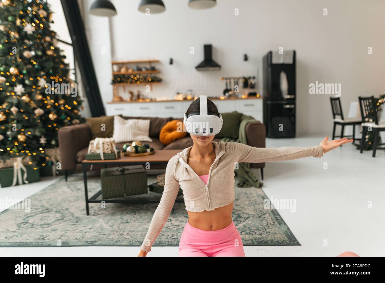 Engrossed in yoga practice, a fitness enthusiast wears virtual reality ...