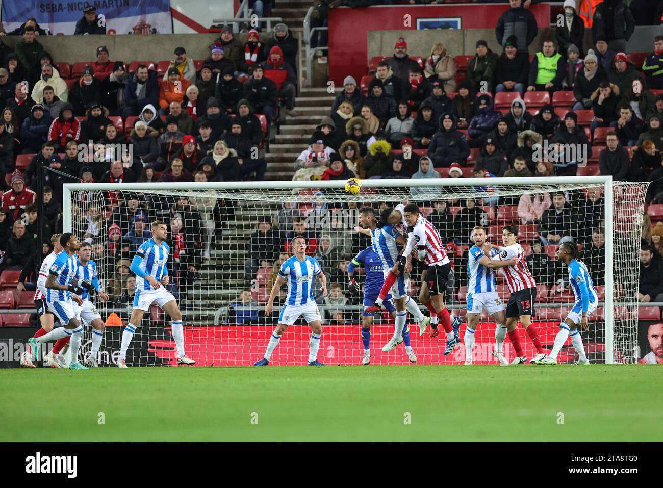 Matty Pearson #4 of Huddersfield Town heads clear of a corner during ...