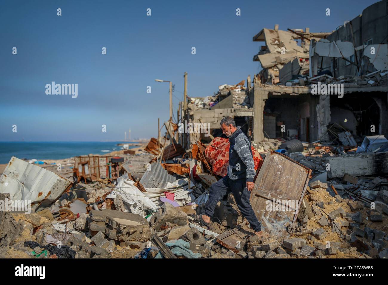 A Palestinian man walks in the rubble of destroyed buildings in Gaza ...