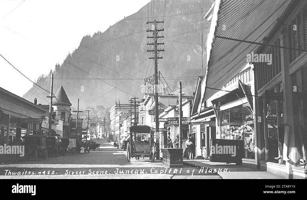 View of street in Juneau, showing sign for the Alaskan Hotel, store ...