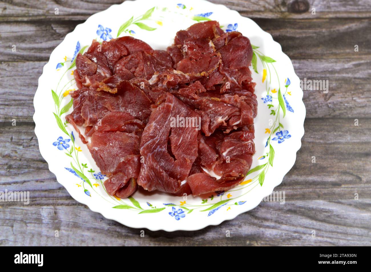 Thin slices of beef pastrami, made from beef brisket, raw meat is ...