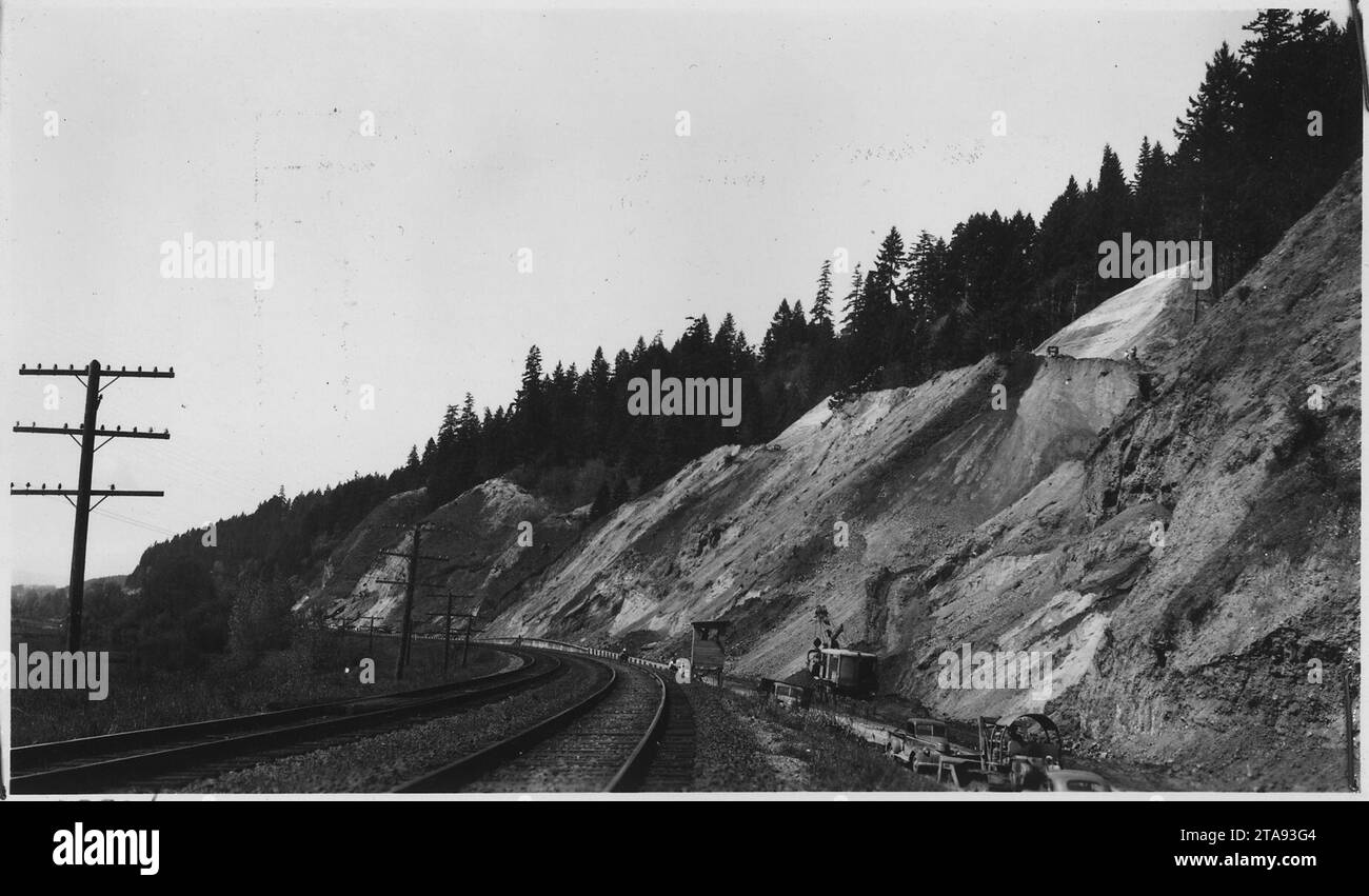 View shows how shovel is operated along existing road to load material ...