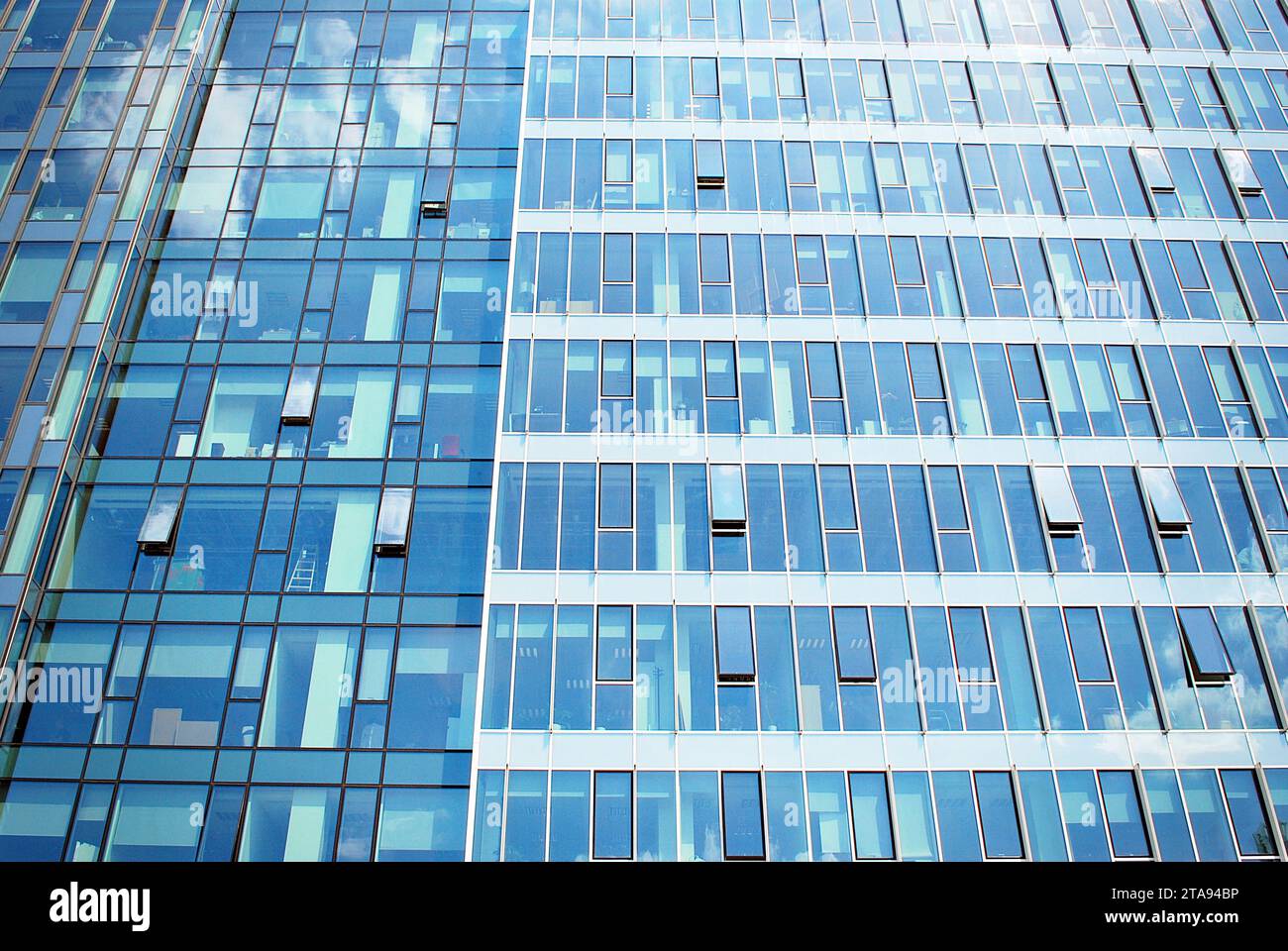 Glass building with transparent facade of the building and blue sky ...