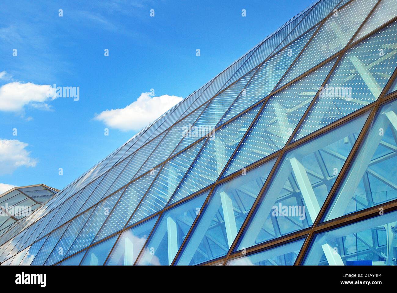 Glass building with transparent facade of the building and blue sky ...