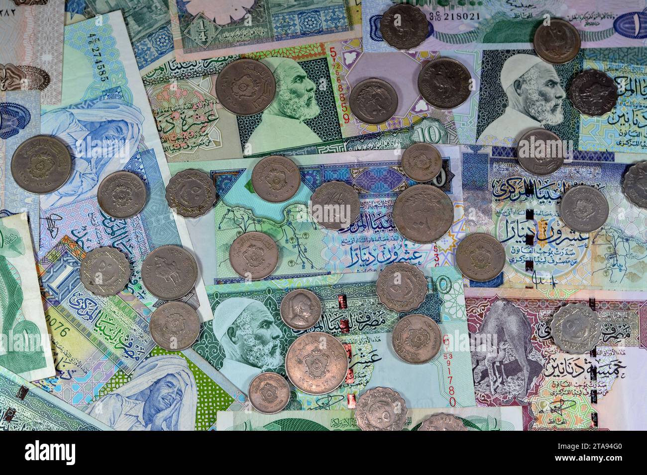 Background of old Libyan money banknote bills and coins of different ...