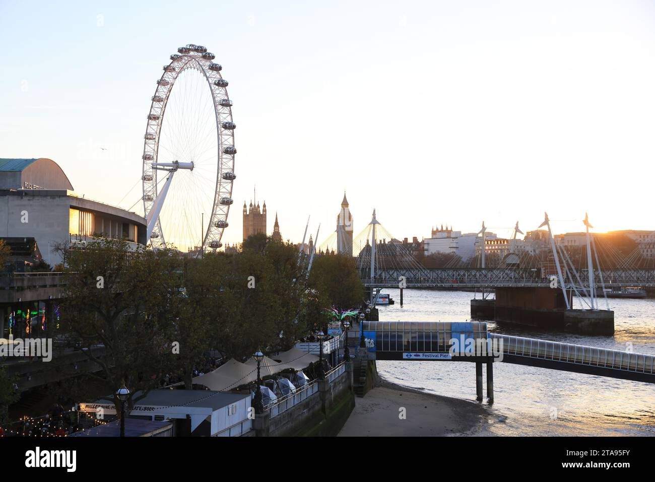 Winter sunset on the River Thames with the London Eye and Big Ben and ...