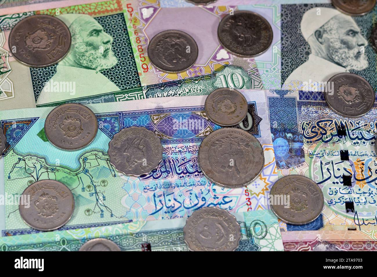 Background of old Libyan money banknote bills and coins of different ...