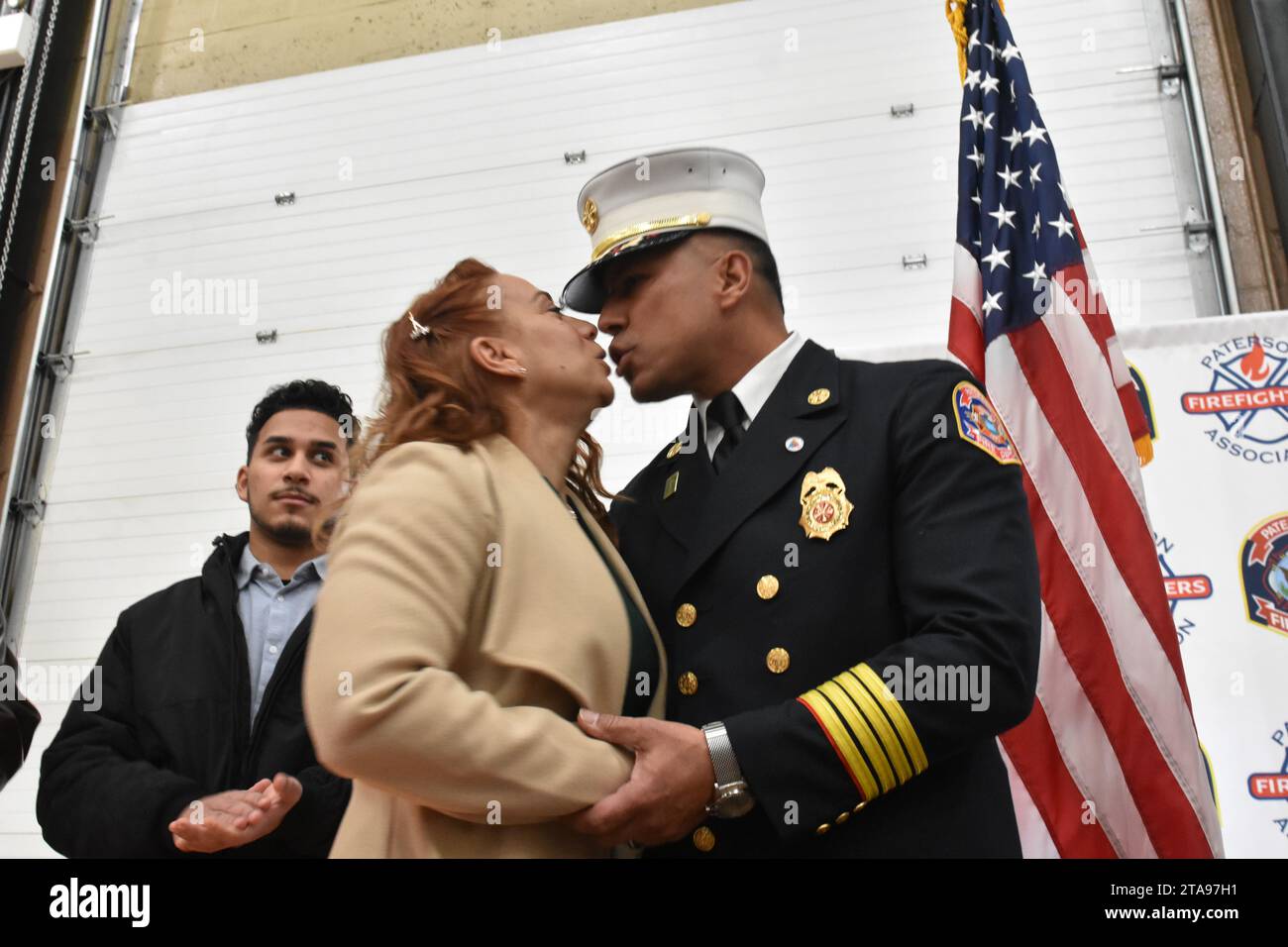 Paterson, United States. 29th Nov, 2023. Alejandro Alicea (R) kisses ...