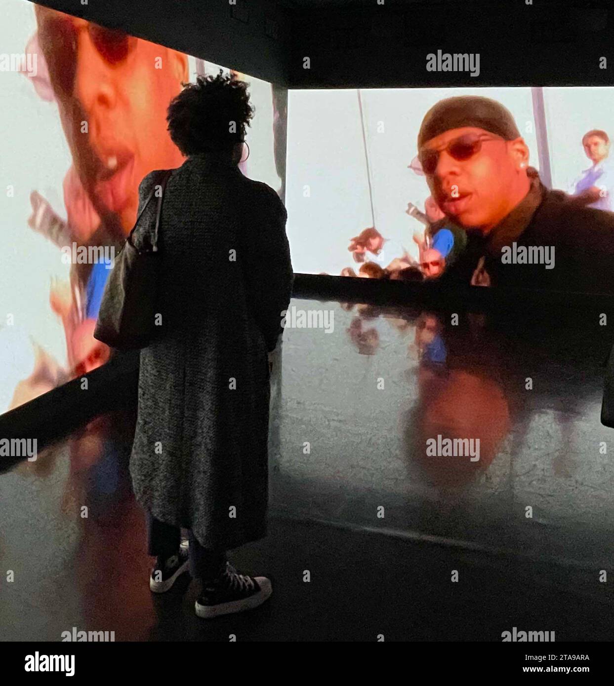 New York, New York, USA. 29th Nov, 2023. A woman views JAy-Z video at ...