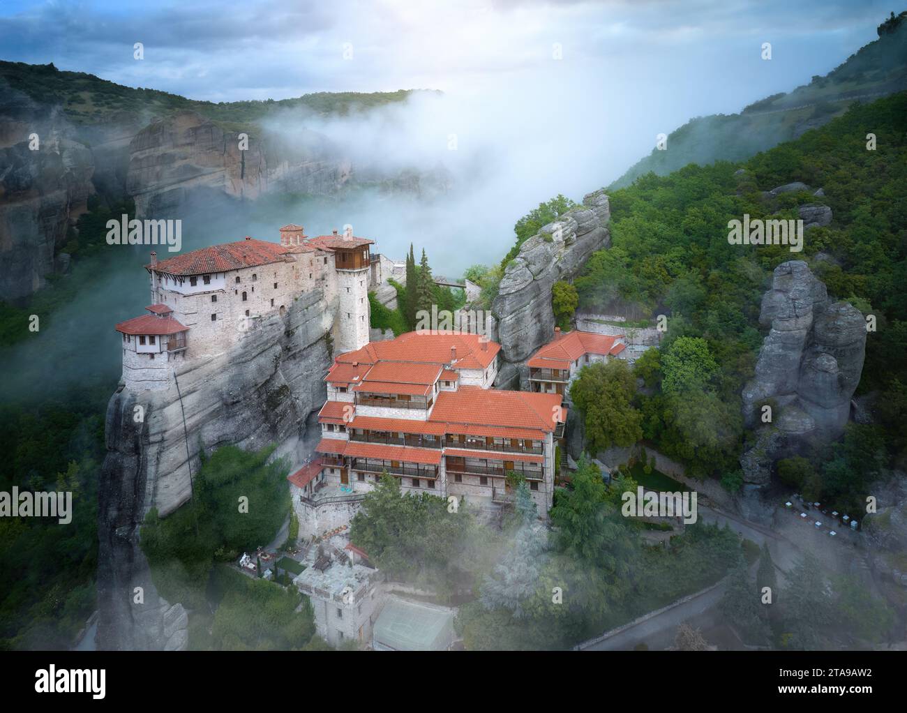 Meteora Monastery of Roussanou rising out of the mist. Aerial, mystical ...