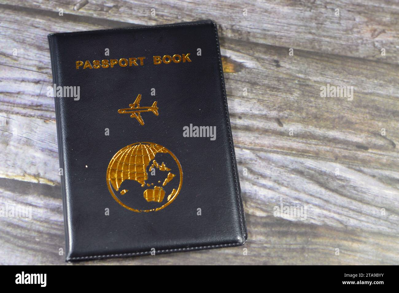 Black passport book with a plane and the globe earth on its cover ...