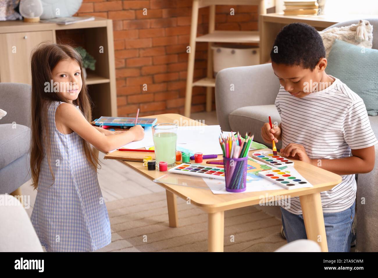Cute little children drawing at home Stock Photo - Alamy
