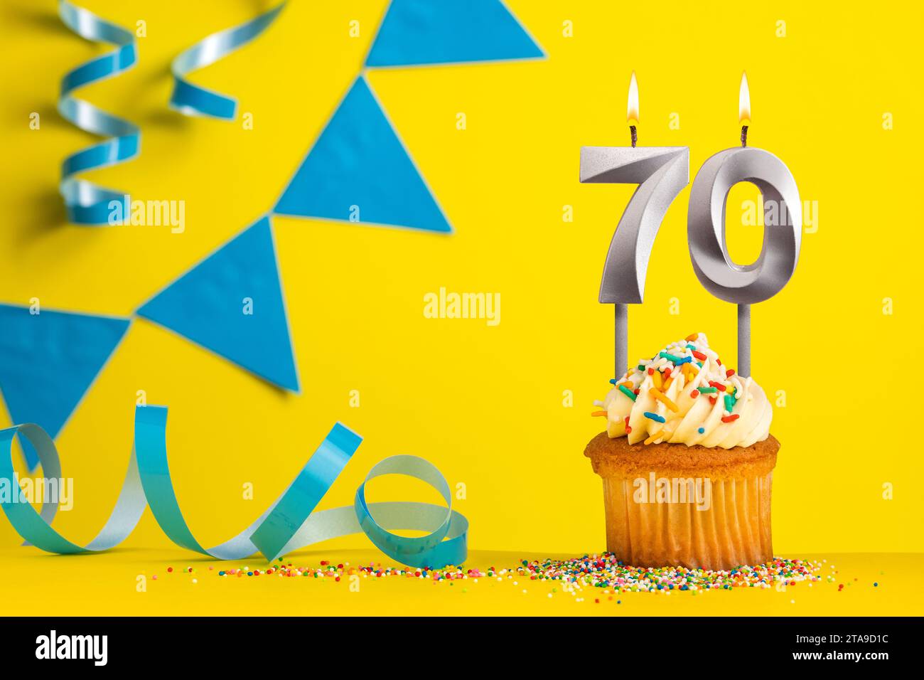 Lighted birthday candle number 70 - Yellow background with blue ...