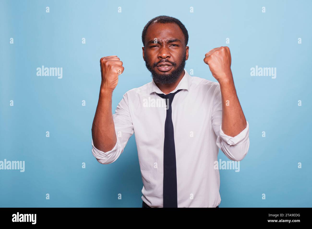 An irritated individual clenches their fists and threatens to fight in ...