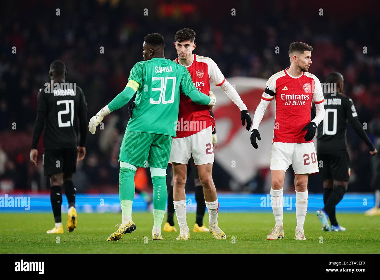 Arsenal's Kai Havertz (centre) embraces Lens goalkeeper Brice Samba ...