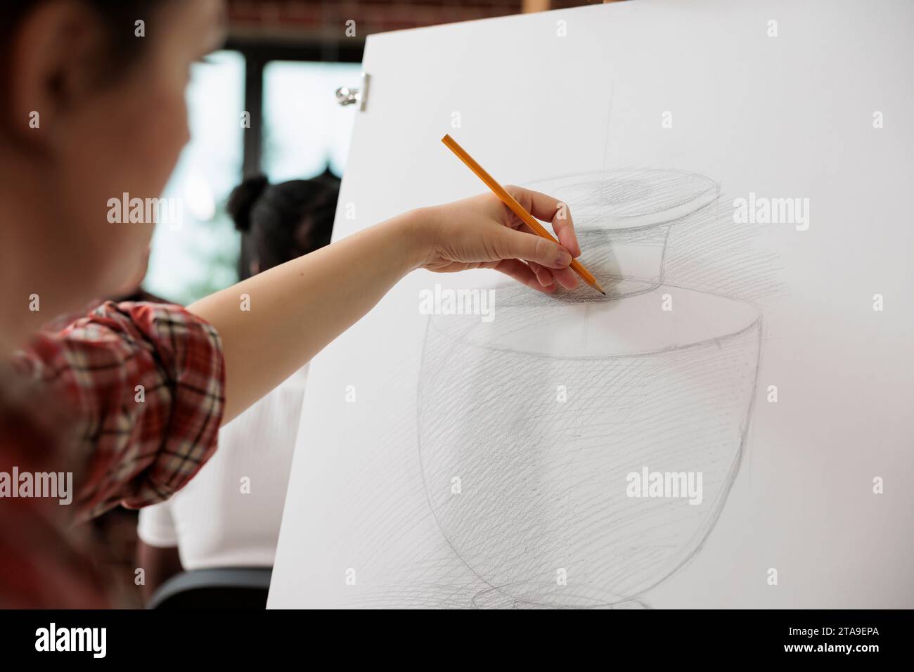 Creative process. Female artist sketching and shading vase with pencil ...