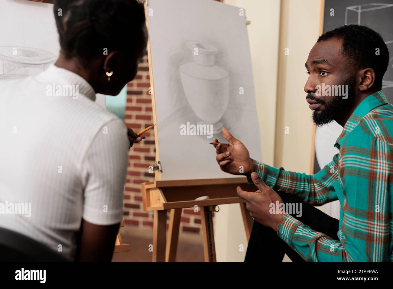 Meeting new friends in art class. Two young African American students ...