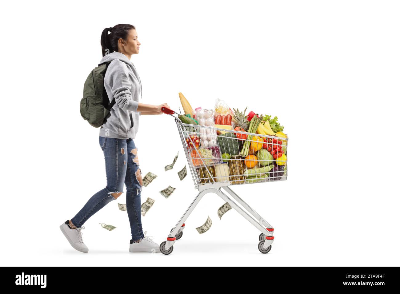 Full length profile shot of a female student walking and pushing a full ...