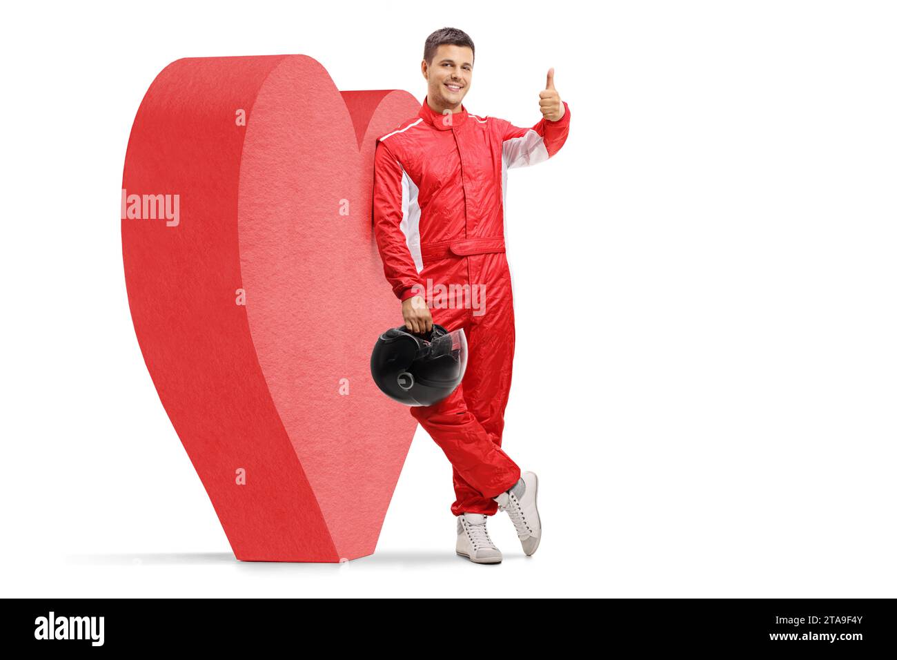 Full length portrait of a racer leaning against a big red heart and ...