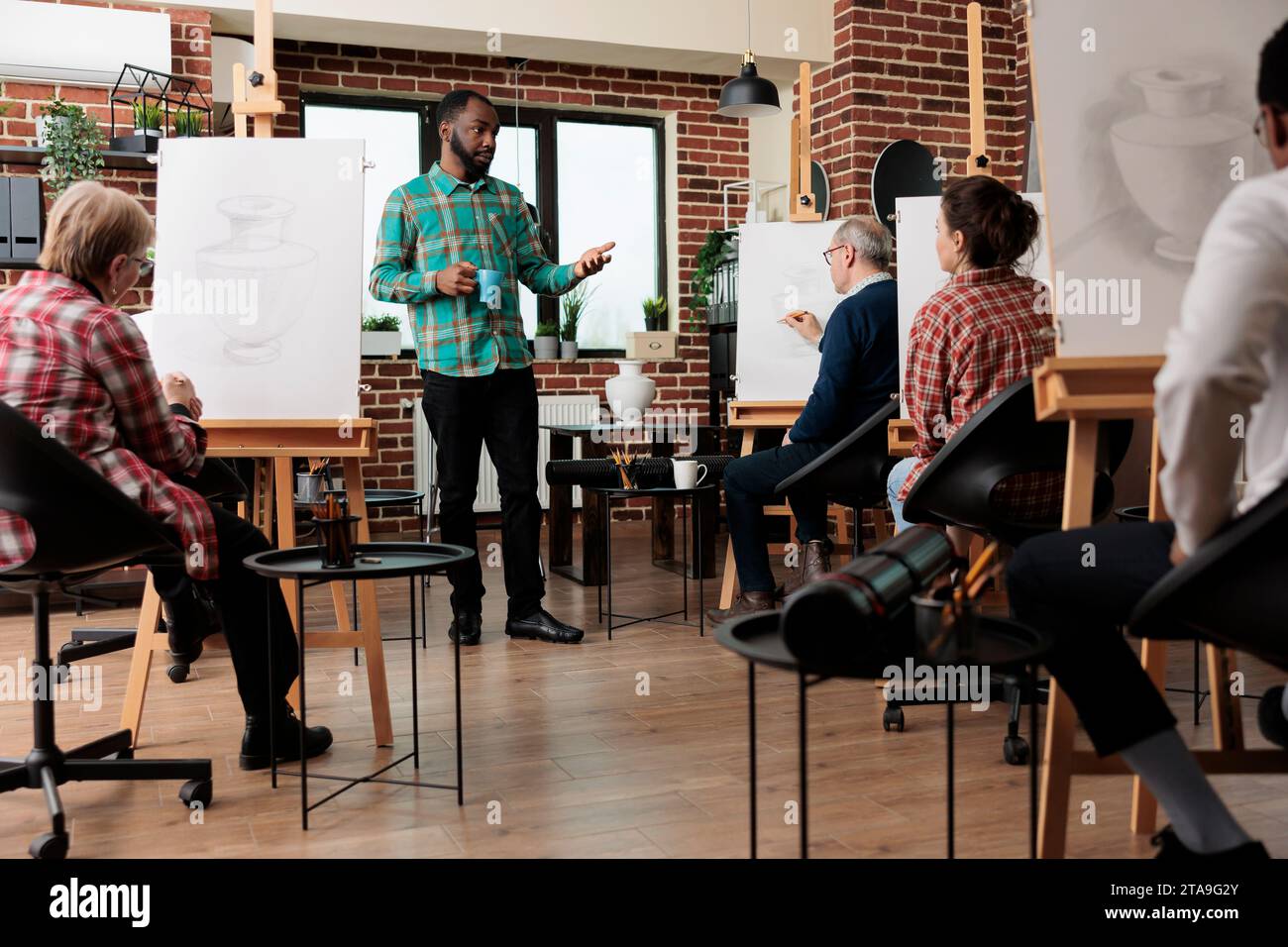 Group of people learn to draw at art studio, enjoying drawing group ...