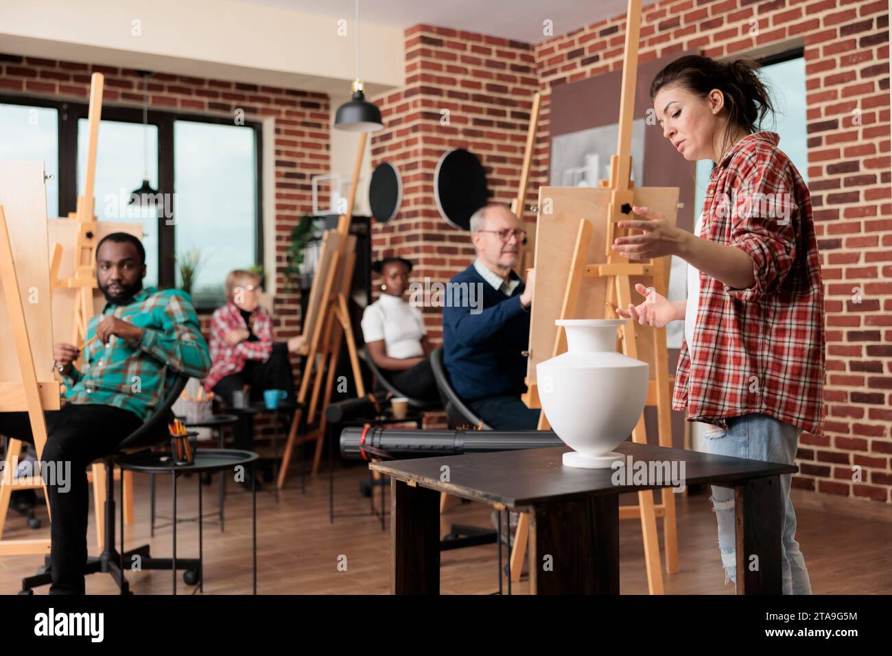 Group of diverse people learn how to draw realistic items, listening ...