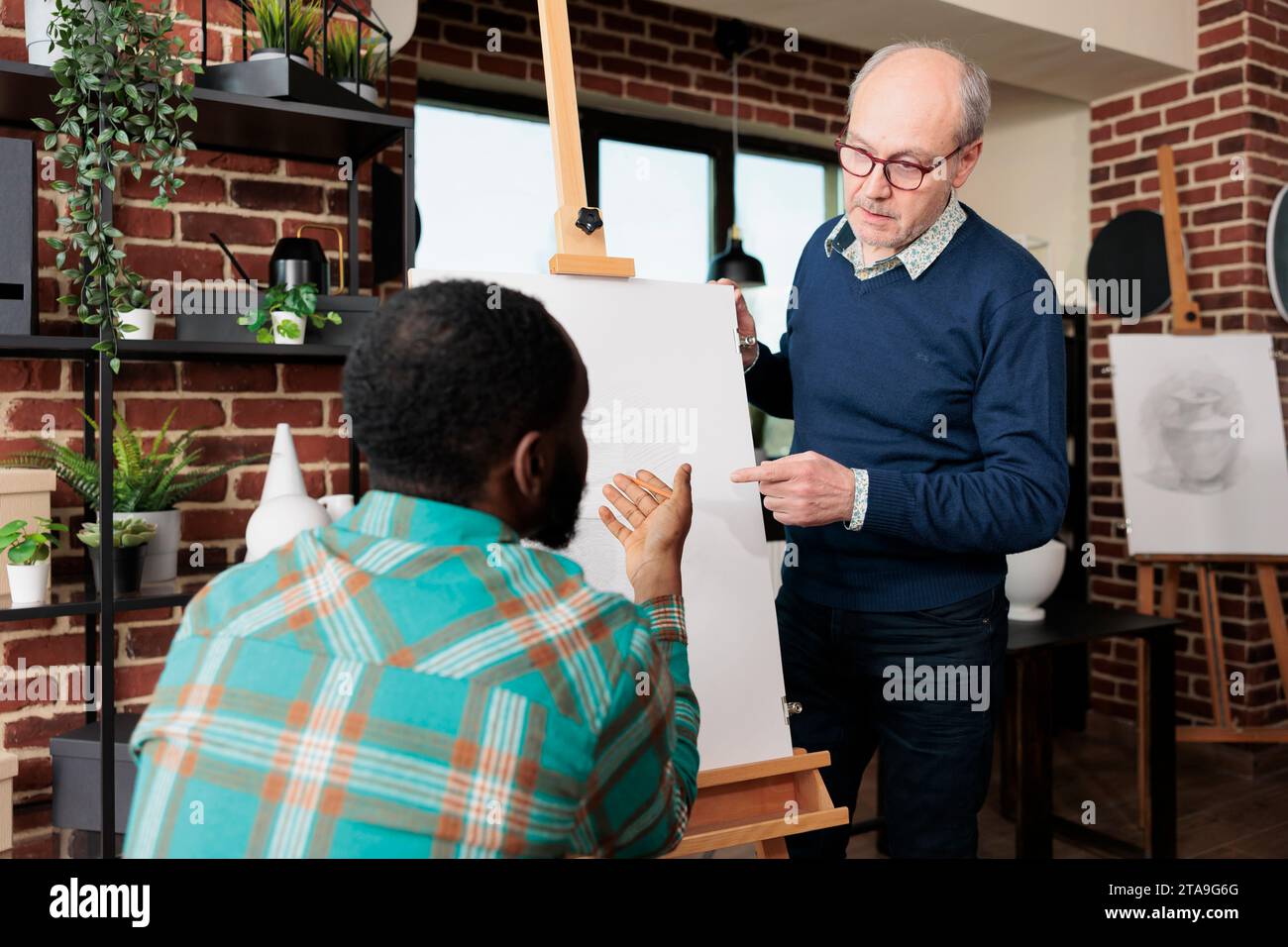 People connecting while learning new skills, two diverse men looking at ...